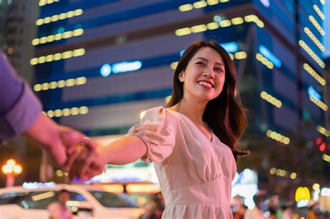 Premium Photo Young Asian Couple Walking On The Street At Night