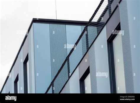 Modern building facade with large windows and striking diagonal pattern ...