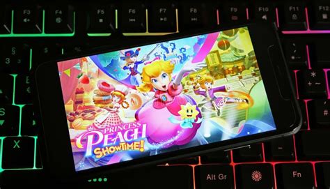 Closeup Of Smartphone On Pc Keyboard With Logo Lettering Of Princess Peach Showtime Game
