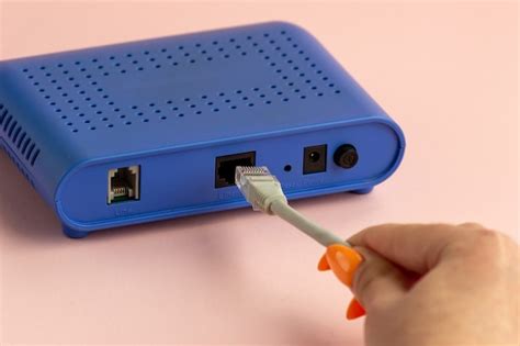 Premium Photo A Woman Plugs An Internet Cable Into A Router Ethernet Connection Concept