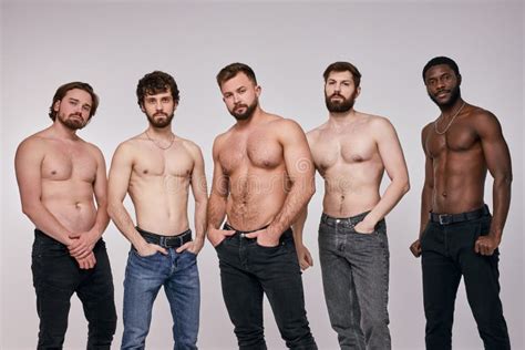 Multi Ethnic Group Of Young Shirtless Men Posing Seriously At Camera