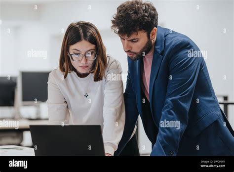Diverse Team Working Late Analyzing Reports And Brainstorming Strategies For Business Growth
