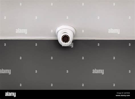 White Security Cctv Camera Or Surveillance Operating On Ceiling Inside