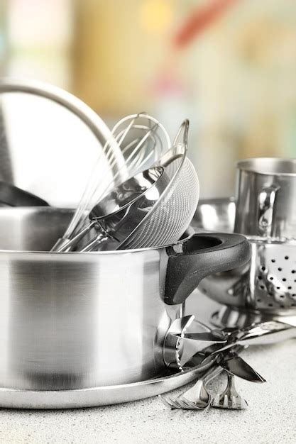 Premium Photo Stainless Steel Kitchenware On Table On Light Background