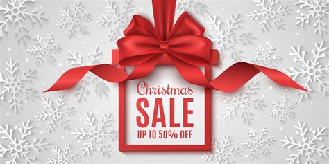 큰 크리스마스 판매를위한 선물 상자 라벨 곱슬 리본으로 사실적인 3d 빨간 활 광고 태그입니다 비즈니스 프로모션을 광고하는 템플릿입니다 상용 할인 이벤트 종이 눈송이의 배경