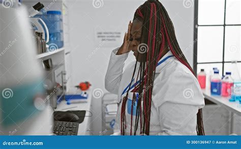 Stressed African American Woman Scientist Experiencing Technology Problems At The Computer In Stressed African American Woman Scientist Experiencing Technology Problems At The Computer In