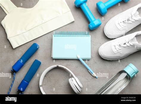Flat Lay Composition With Sportswear Notebook And Equipment On Grey