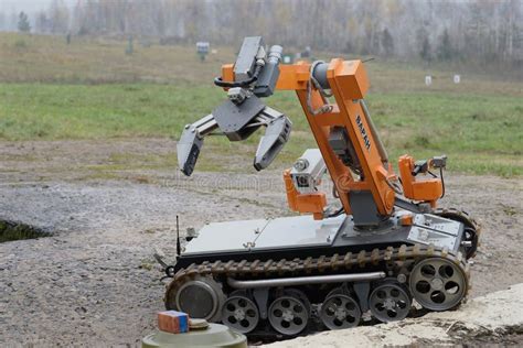 Worker Control Robot Arm To Loading And Unloading Workpiece Editorial