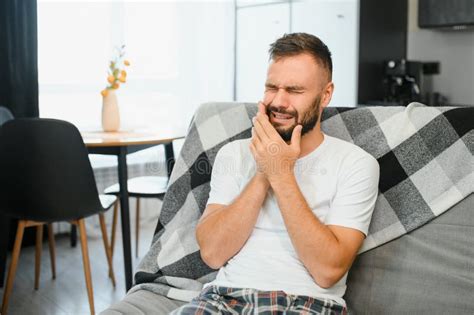 Man With Sensitive Teeth Suffering From Pain At Home Stock Image