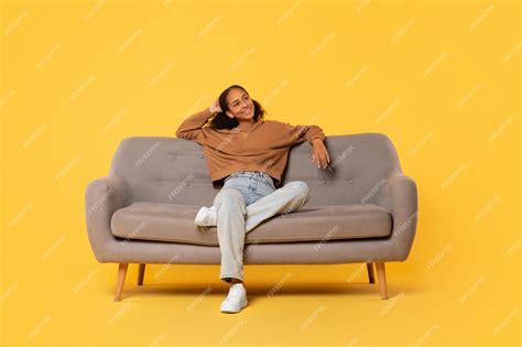 Premium Photo Relaxed Black Teenager Girl Lounging On Couch