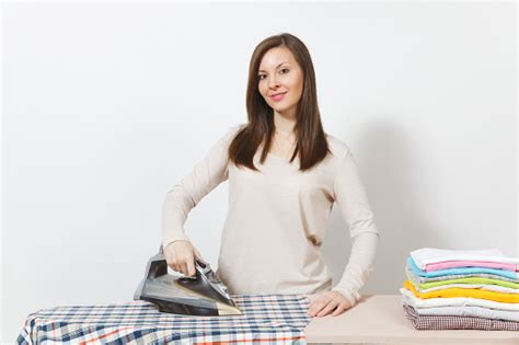 다리미와 다림 질 보드 의류 그녀의 남편의 셔츠를 다림 질 하는 가벼운 옷에 젊은 매력적인 주부 흰색 배경에 고립 된 여자입니다 가사 개념입니다 광고에 대 한 공간을 복사