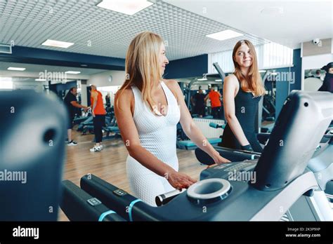 Mother And Teen Babe In Sportswear Exercise On Treadmill At The Gym Stock Photo Alamy