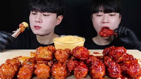 Two Men Are Eating A Plate Of Chicken Wings Wallpaper Wallpapersok