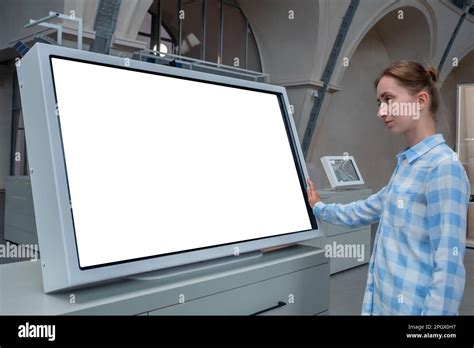 Woman Looking At Interactive White Touchscreen Display Kiosk At Exhibition Stock Photo Alamy