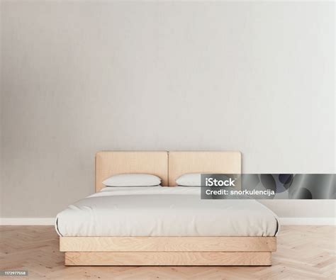 현대적인 인테리어 배경의 수평 모형 포스터 프레임 흰색 침실의 깨끗한 침구가있는 자연 채광 나무 침대 프레임 스칸디나비아 스타일