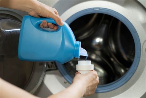 Premium Photo Women Add Laundry Detergent To The Washing Machine