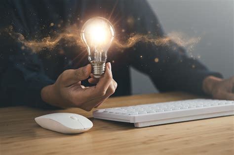 Premium Photo Business Man Holding Light Bulb And Laptop Keyboard And Mouse New Idea