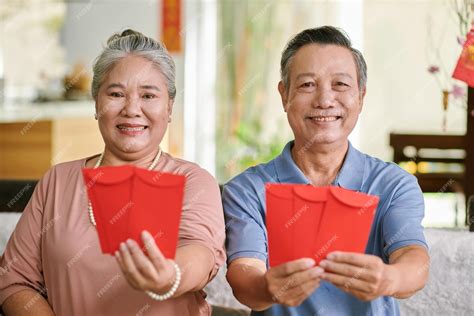 Premium Photo Elderly Couple Showing Red Evelope