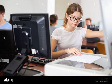 Smart Female Teenager Learning Computer Science While She Is Using A PC And Scanner In The
