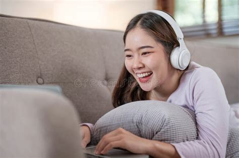 Happy Young Woman Using Laptop At Home Sitting On Soft Couch Lady Is