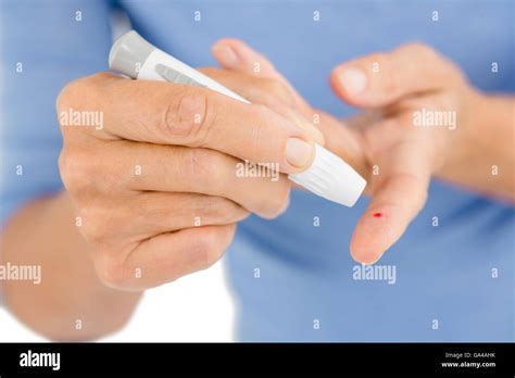 Woman Using Blood Glucose Monitor Stock Photo Alamy