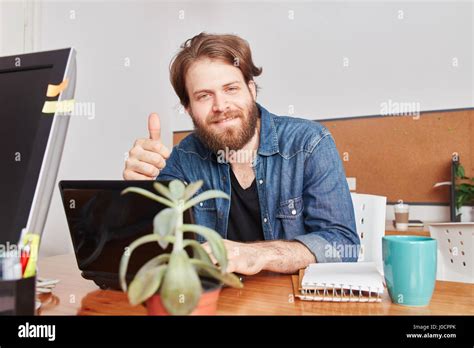 man as successful founder with thumbs up at programmer startup stock