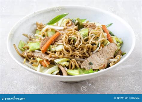 Traditional Japanese Pork With Yakisoba Noodles And Vegetable In A