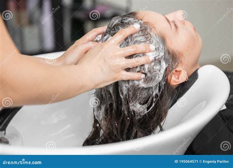 Shampooing Hair In Spa Beauty Salon Of Young Brunette Woman