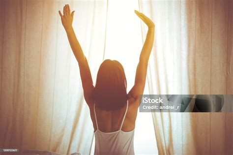Woman Stretching Hands In Bed After Wake Up Sun Flare Brunette Entering A Day Happy And Relaxed