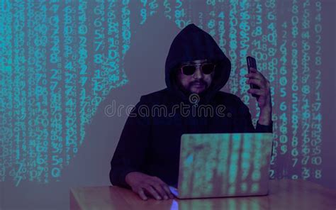 a hacker uses a malware with mobile phone and laptop to hack password
