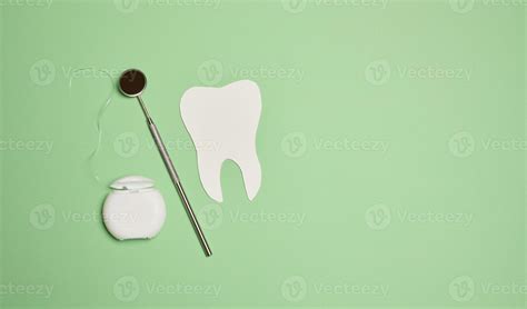 Dental Floss And Paper Teeth On Green Background Oral Hygiene 44041647