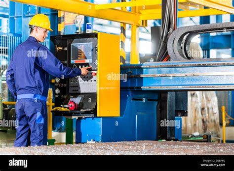 Worker In Manufacturing Plant At CNC Machine Control Panel Stock Photo Alamy