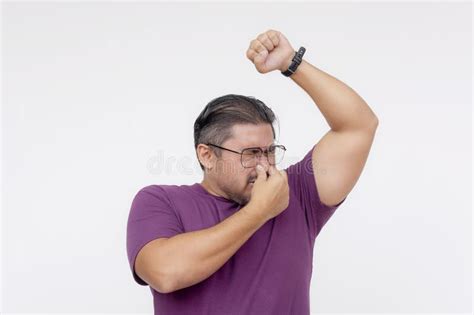 A Middle Aged Man Cover His Nose From The Strong Smell Emanating From