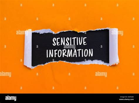Sensitive Information Message Written On Ripped Torn Orange Paper With Black Background