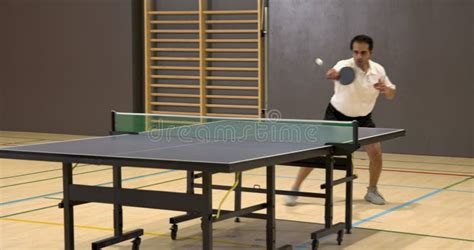 Playing Table Tennis Man Hitting Ball With Paddle In Indoor Sports