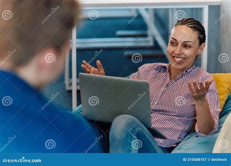 A Modern Programmer Discussing Future Business Projects With Colleagues In A Modern Startup
