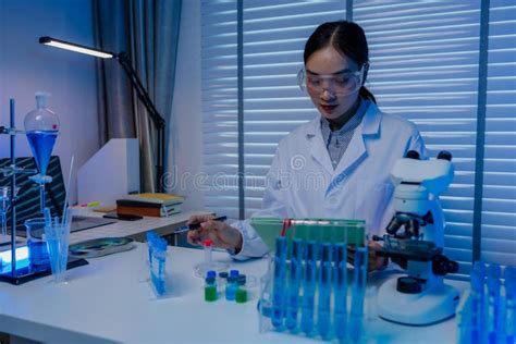 A Female Scientist Is Experimenting With Chemicals In A Lab Science Experiments Often Require A