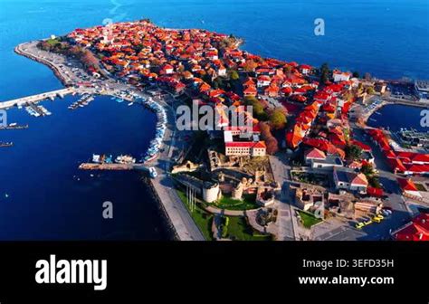 Top View Of A Dense Ancient Town On A Peninsula With Red Tiled Roofs