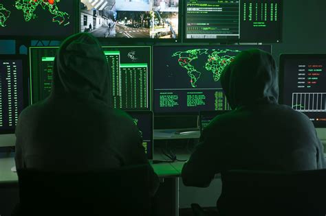 Team Of Computer Hackers Coding On Keyboard Hidden In Illegal Hideout