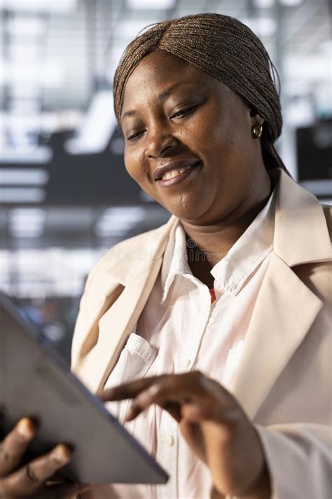 Joyous Businesswoman Compiling Financial Reports Using Tablet Stock