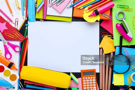 Different School Supplies With Blank Sheet Of Paper On Blackboard Stock