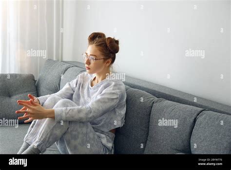 Redhead Girl In Pajamas And Glasses Sits On The Couch 6 Hugging Her