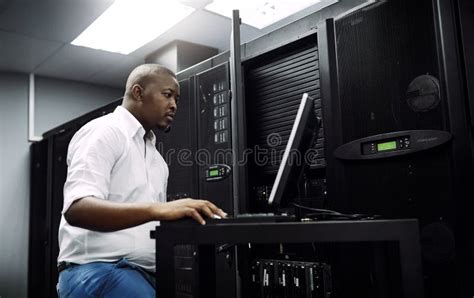 Engineer Black Man Or Coding On Laptop In Server Room For Big Data