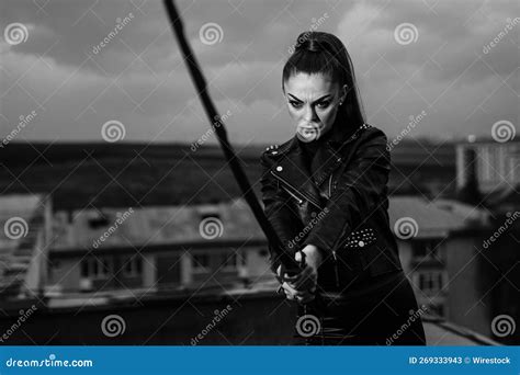 Grayscale Of Female In Black Ninja Assassin Costume Holding A Sword And