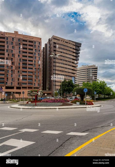 Detail Of Avenue With Buildings In An Urban Area With A Cloudy Sky At