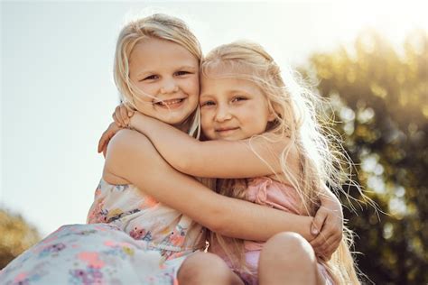 Premium Photo Hug Nature And Portrait Of Girl Siblings Bonding