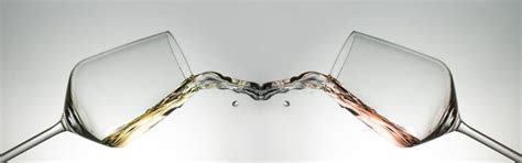 Two Cups Of White And Rose Wine Spilling In Front Each Other Stock
