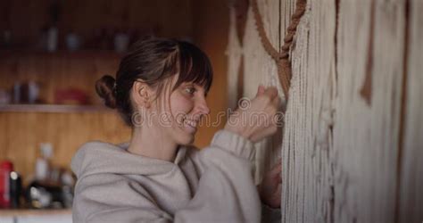 Happy Girl Doing Macrame And Making Knots On Strings While Relaxing In