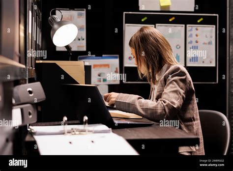 Police Officer Solving Criminal Case Analyzing Crime Scene Evidence Working Overhours In Arhive