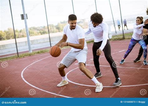 Multiethnic Young People Playing Basketball On Court Stock Image